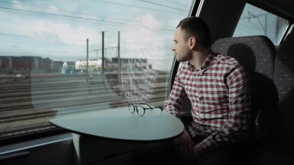 Boy looking out train window outside, in the evening, travel. 4K ...