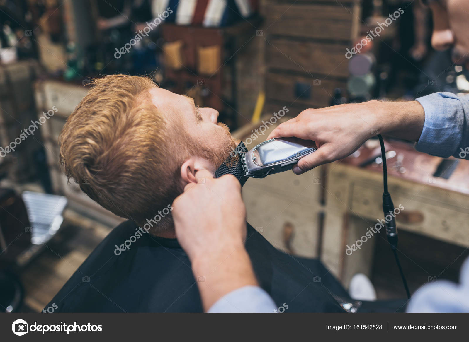 Barber trimming customers beard — Stock Photo © SashaKhalabuzar #161542828