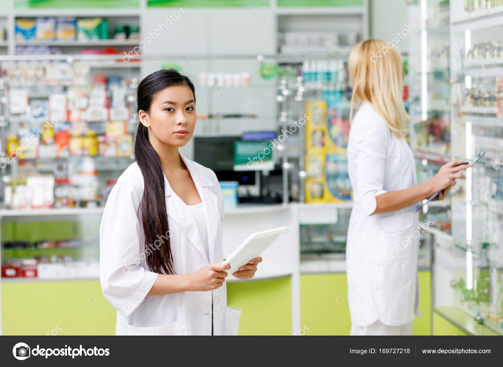 Asian pharmacist with digital tablet — Stock Photo © SashaKhalabuzar ...
