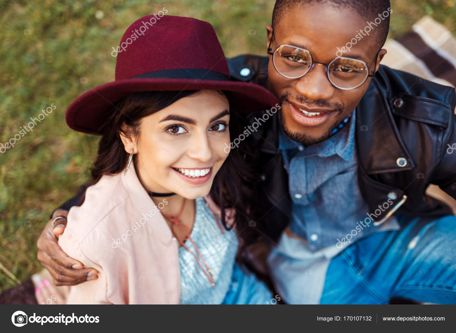 Multicultural couple sitting on grass — Stock Photo © SashaKhalabuzar ... Multicultural couple sitting on grass — Stock Photo © SashaKhalabuzar ...
