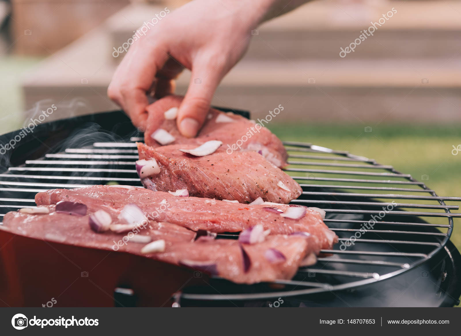 Man roasting meat — Stock Photo © DimaBaranow #148707653