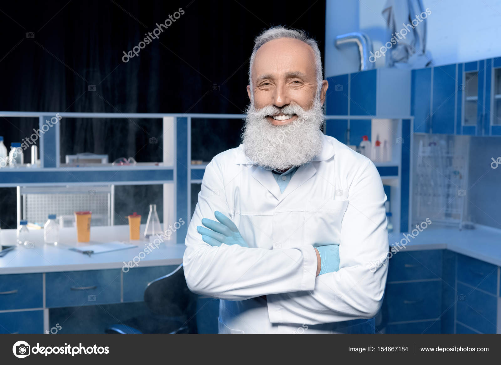 Grey haired scientist with arms crossed — Stock Photo © DimaBaranow ...