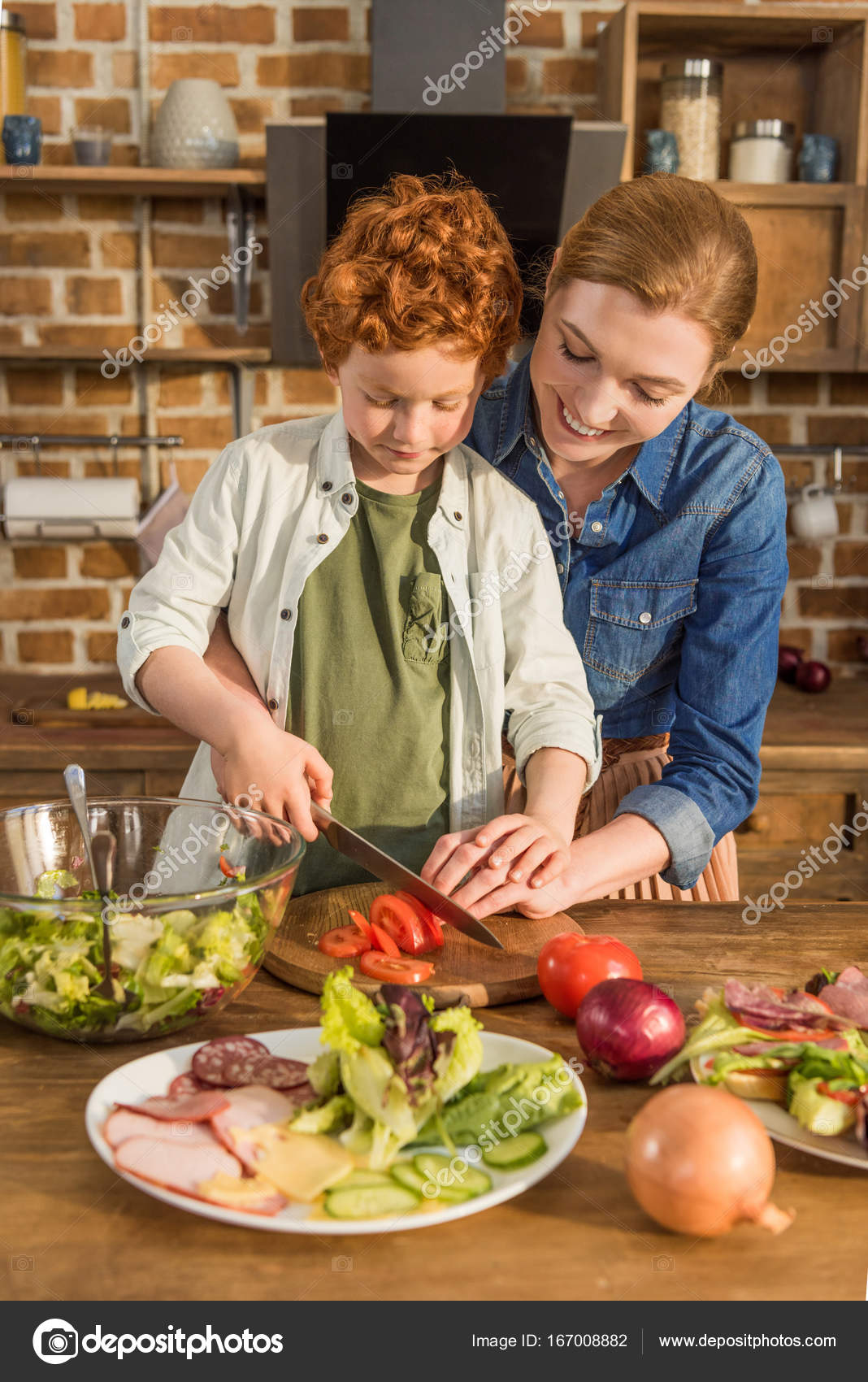 Son helping mother cooking dinner — Stock Photo © DimaBaranow #167008882