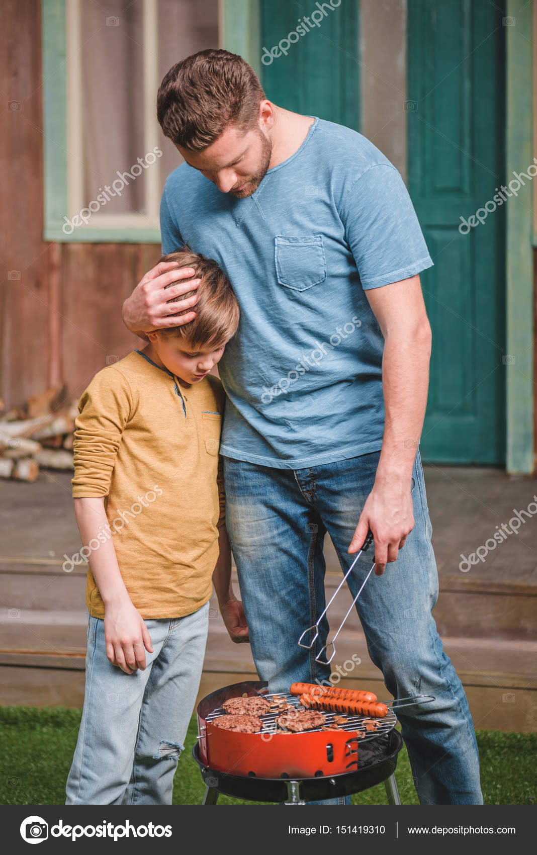 Father and son on barbecue Stock Photo by ©AlexLipa 151419310