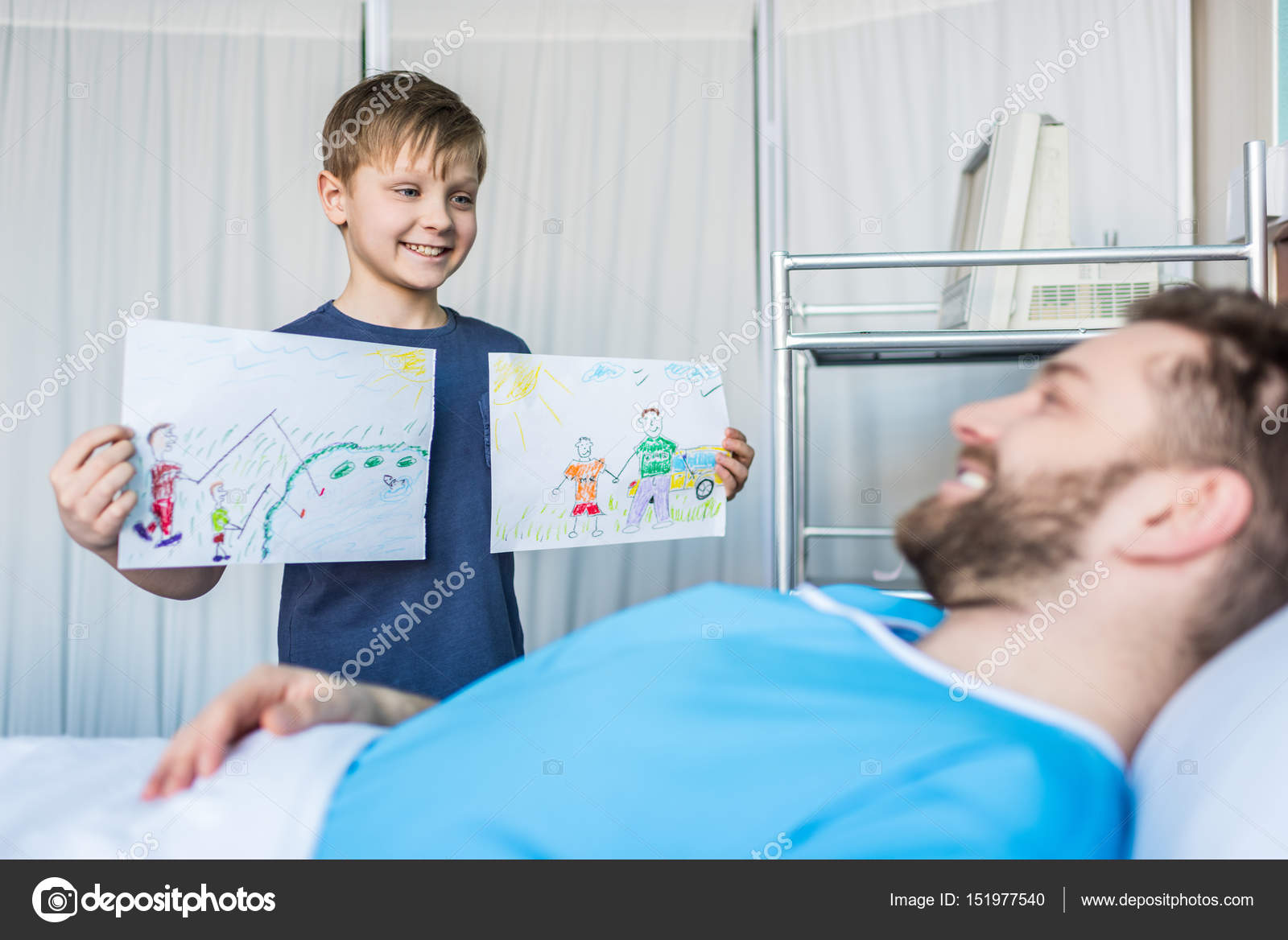 Son showing sick father drawings — Stock Photo © AlexLipa #151977540