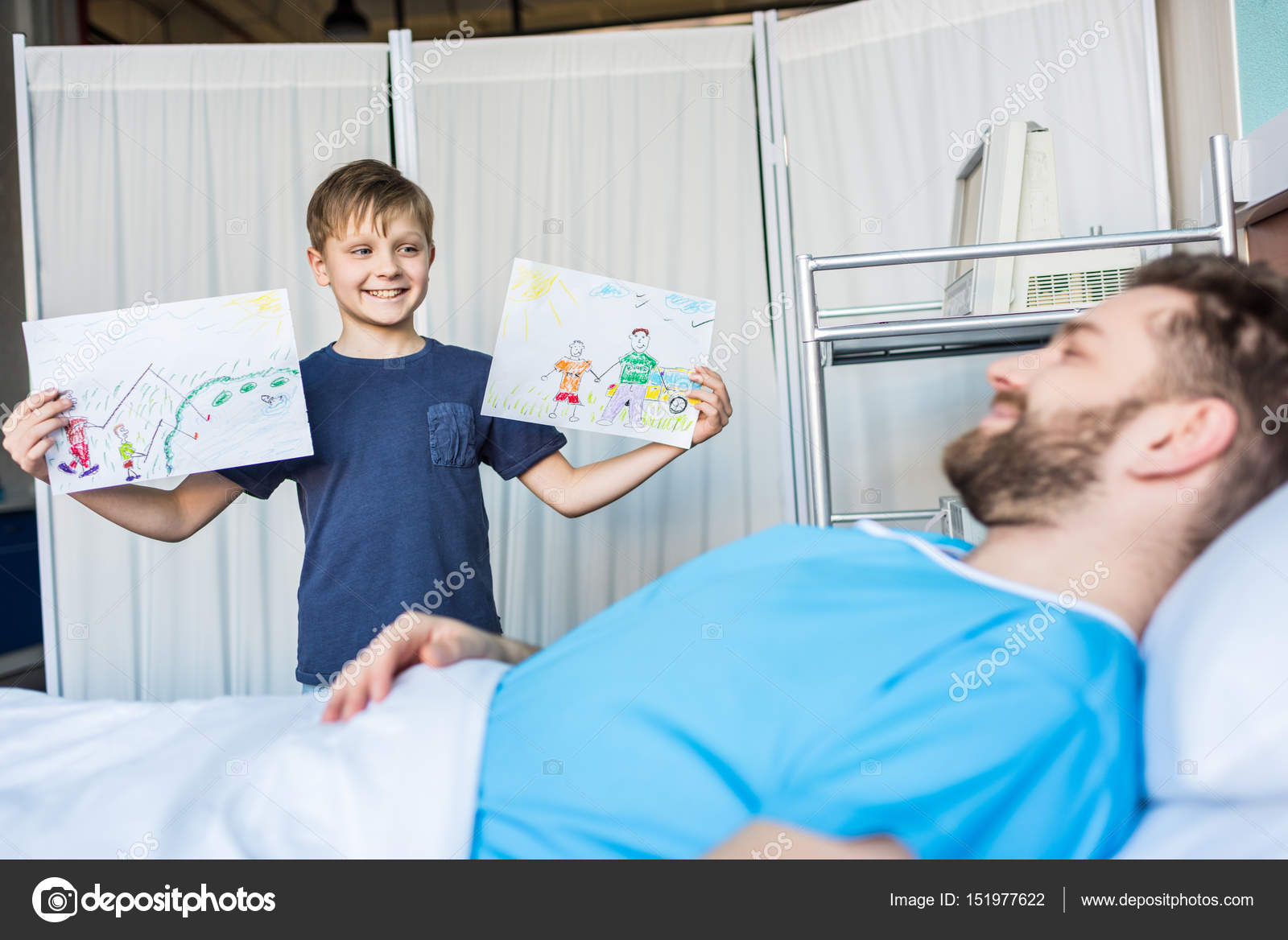 Son showing sick father drawings — Stock Photo © AlexLipa #151977622