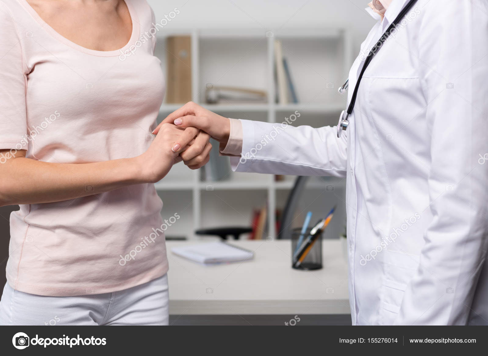 Doctor and patient holding hands — Stock Photo © AlexLipa #155276014