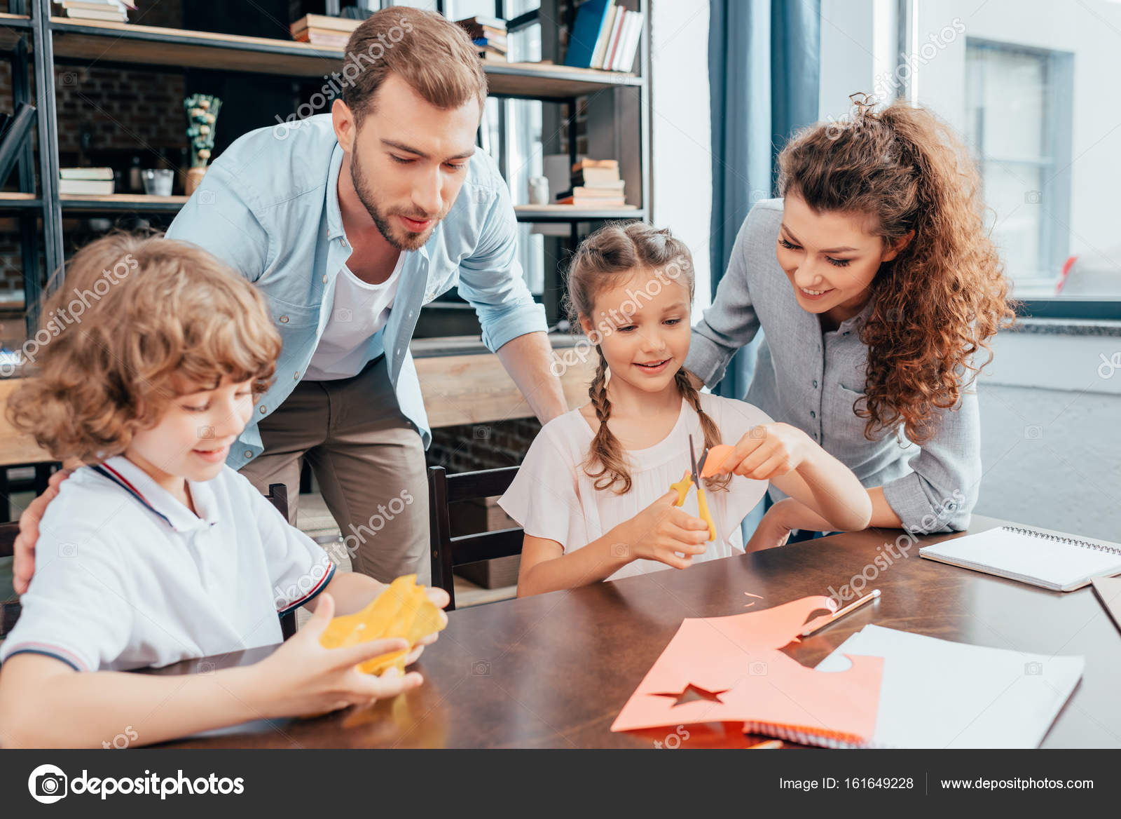 Parents doing homework with kids — Stock Photo © AlexLipa #161649228