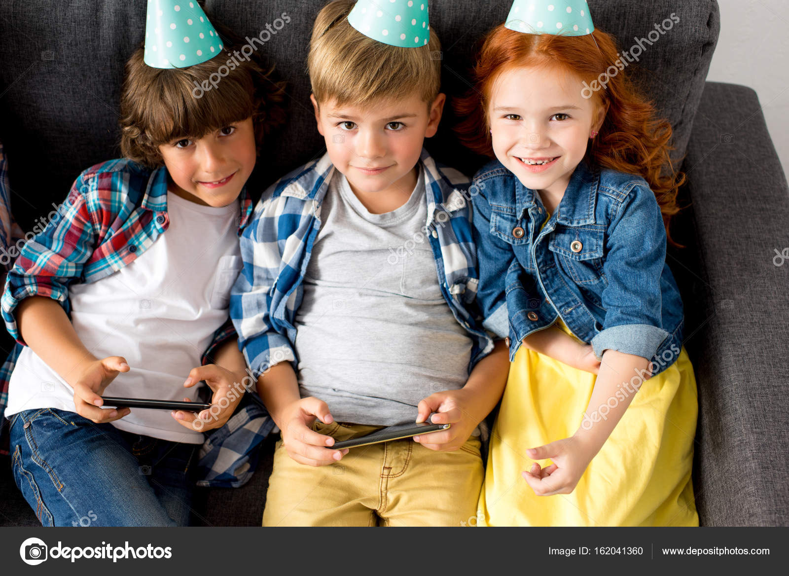 Kids using gadgets at birthday party — Stock Photo © AlexLipa #162041360