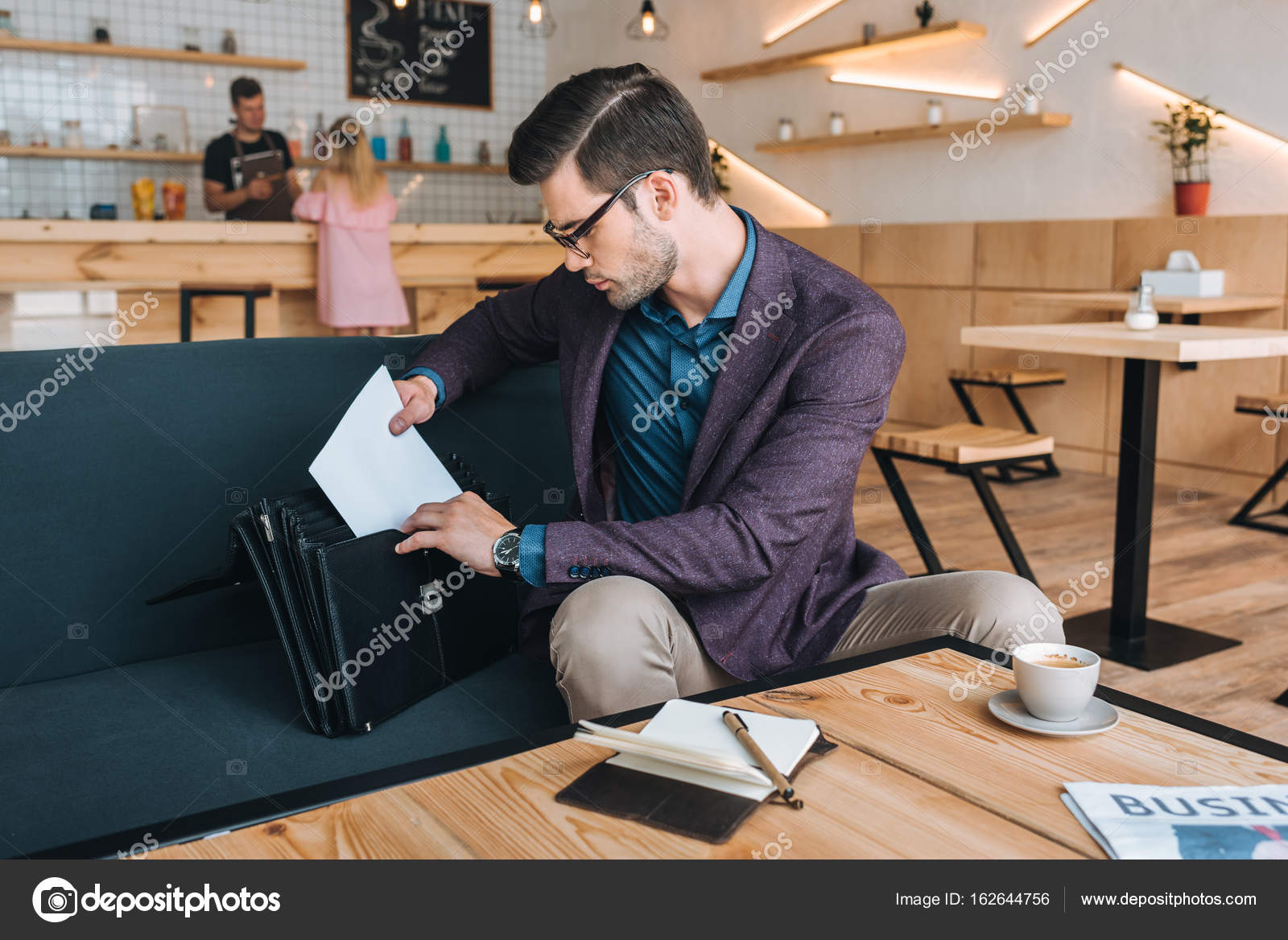 Businessman putting documents in briefcase — Stock Photo © AlexLipa ...