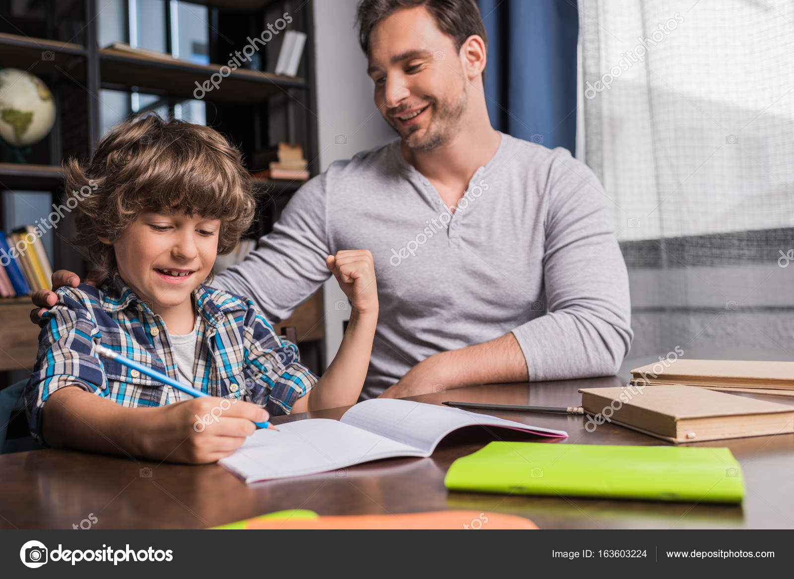Son doing homework with father — Stock Photo © AlexLipa #163603224