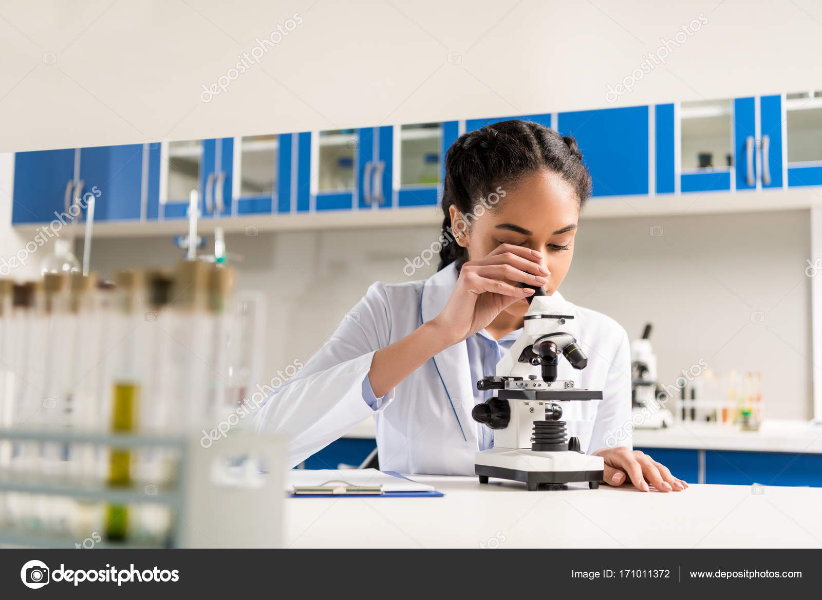 Technician using microscope in laboratory — Stock Photo © AlexLipa ...