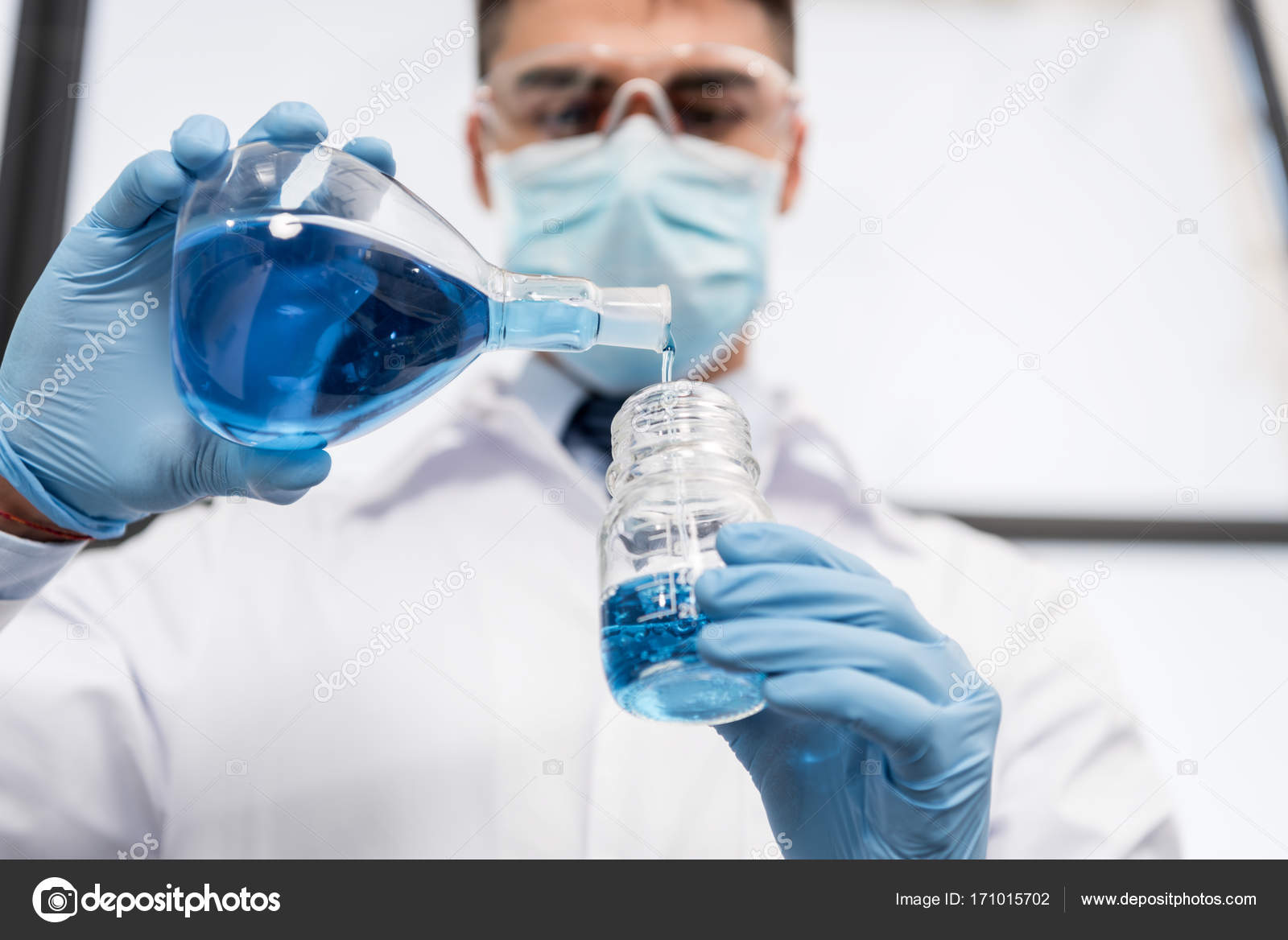 Scientist pouring reagent into jar — Stock Photo © AlexLipa #171015702