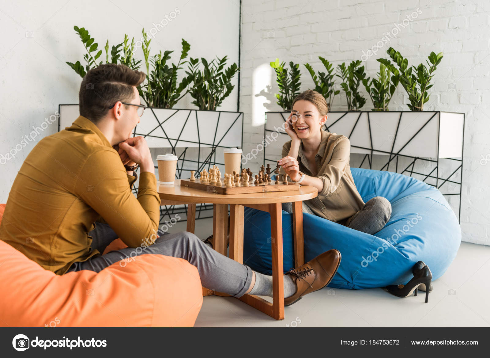 Young Happy Friends Playing Chess While Sitting Beanbags — Stock Photo ...