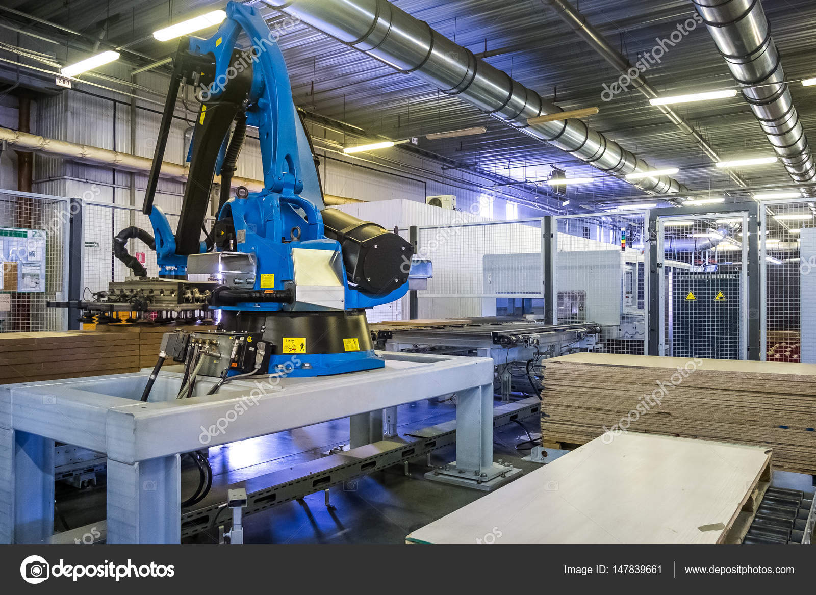 Automatic self-contained robot loader in production Stock Photo by ...