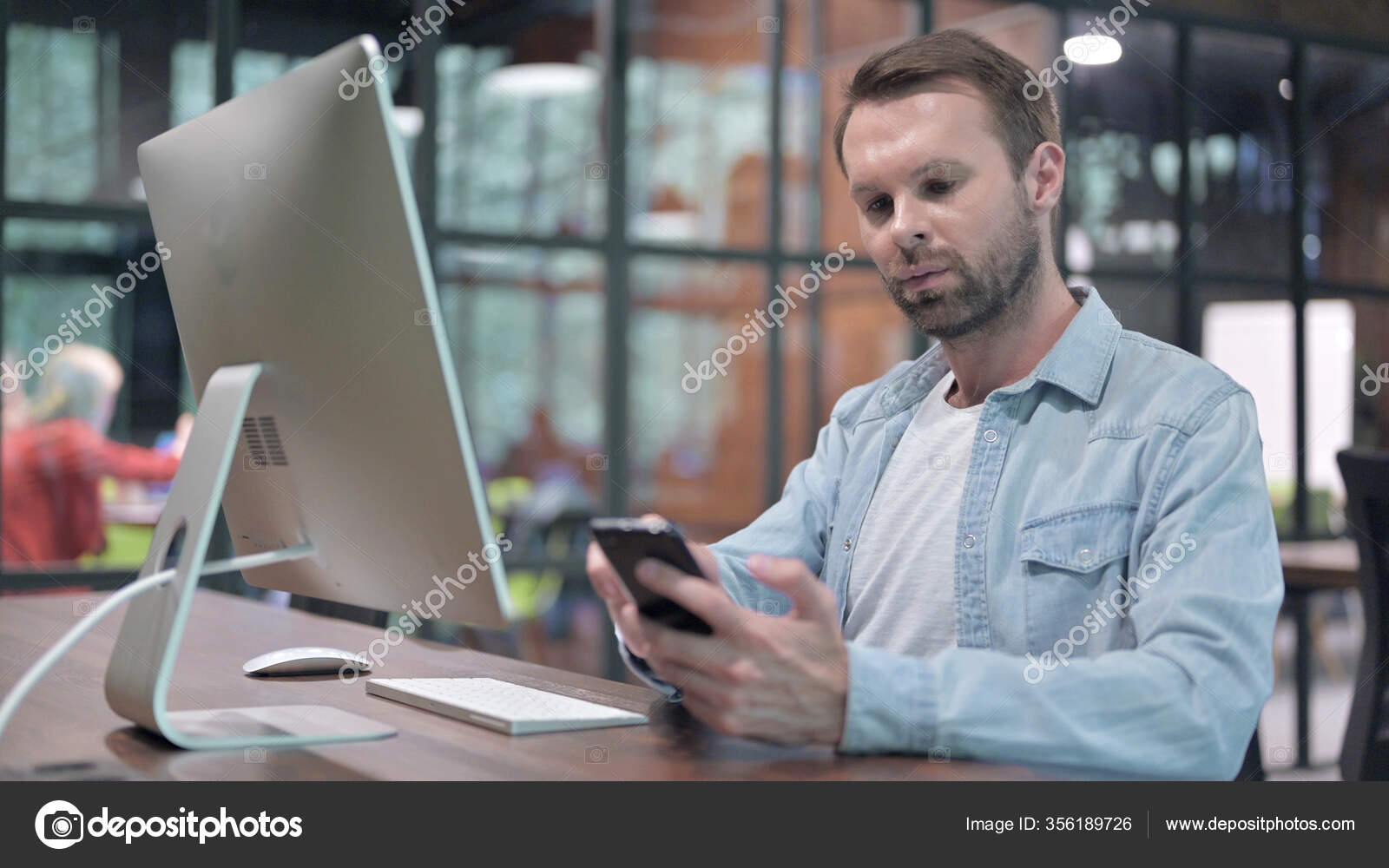 Young Man Using Smartphone at Work — Stock Photo © mustang.marshal ...
