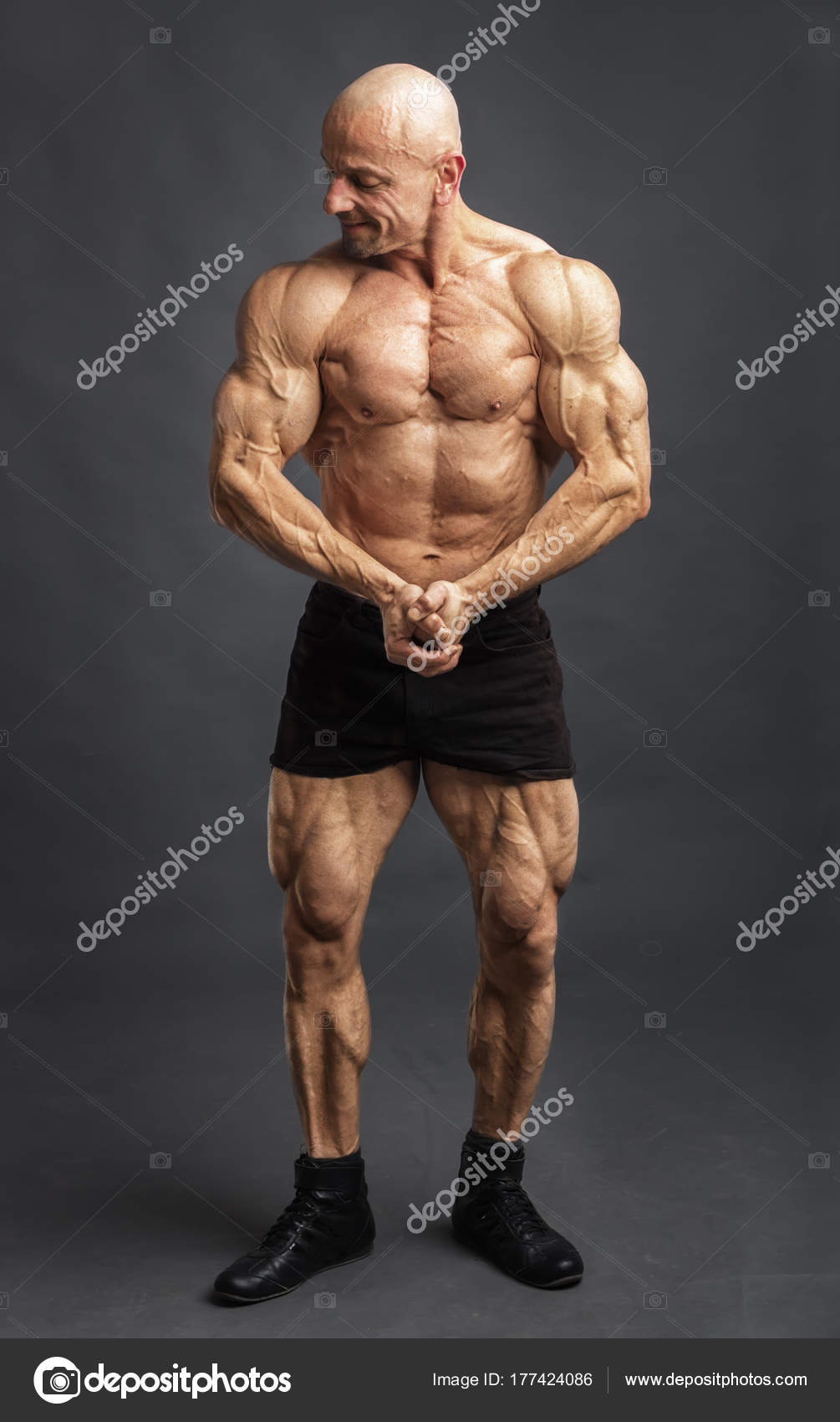 Athlete in front pose. Bodybuilder showing muscles and motivating to ...
