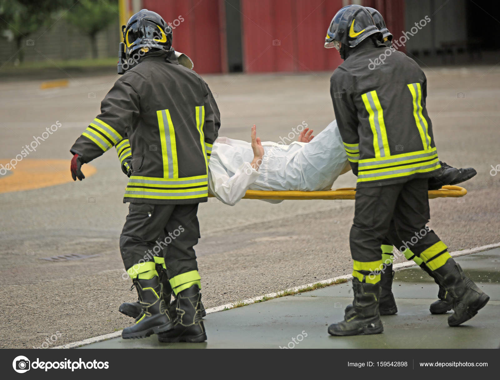 Firefighters help the wounded with the stretcher ⬇ Stock Photo, Image ...
