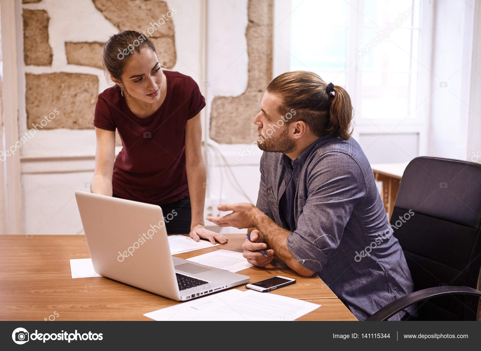 Two young professionals in discussion Stock Photo by ©pablocalvog 141115344