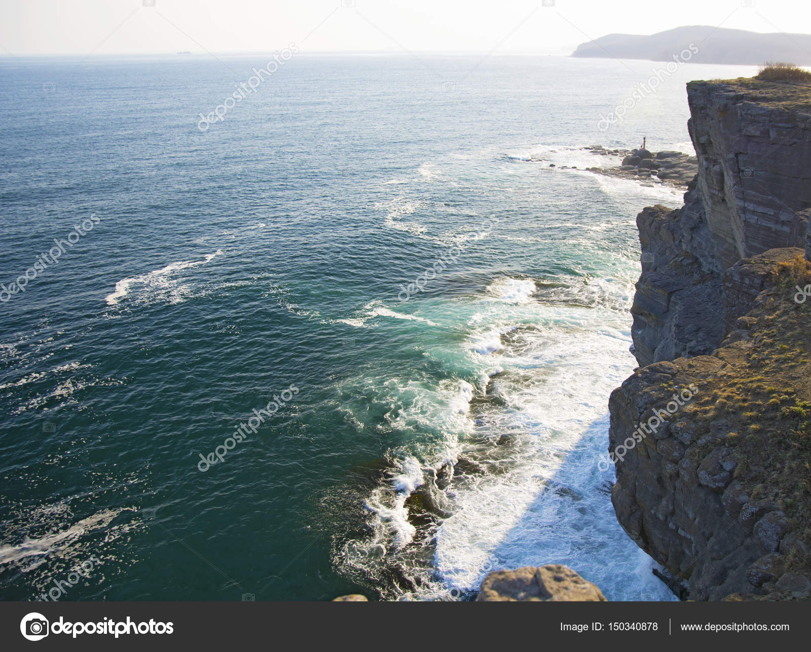High cliff above the sea, the cliff descends into the sea, many ...