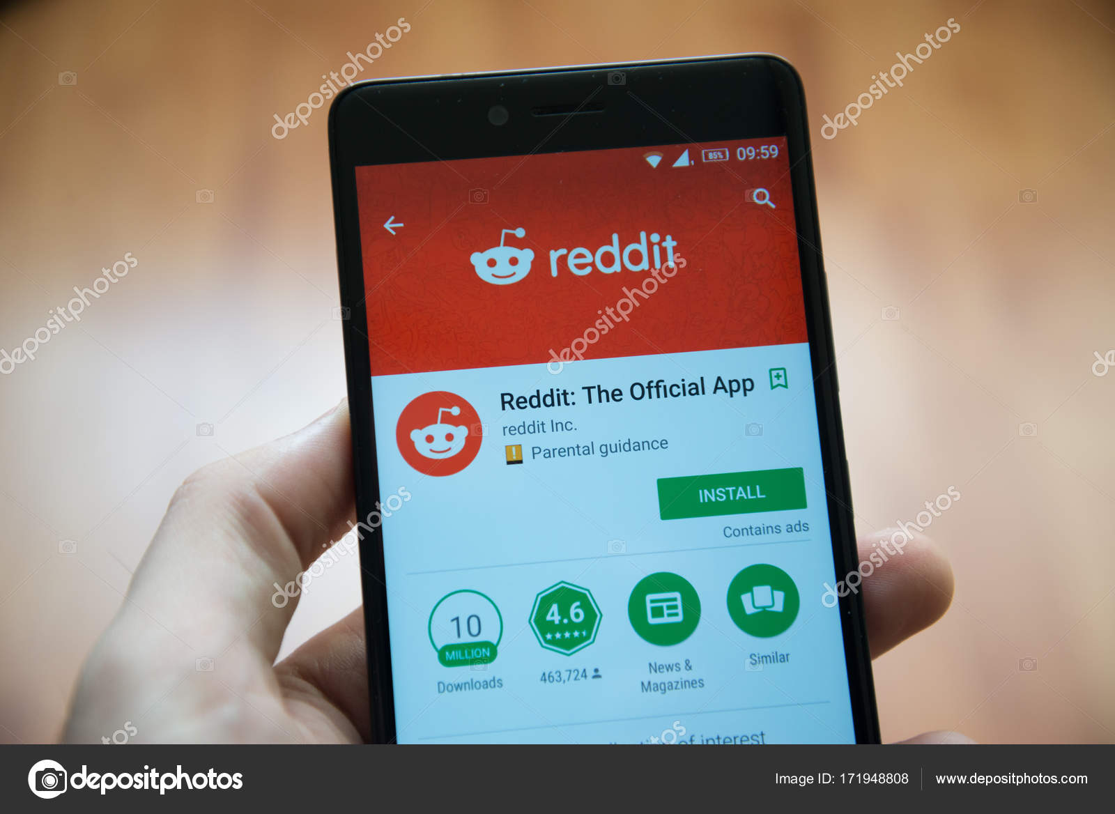 Man hand holding smartphone with Reddit application in google play ...