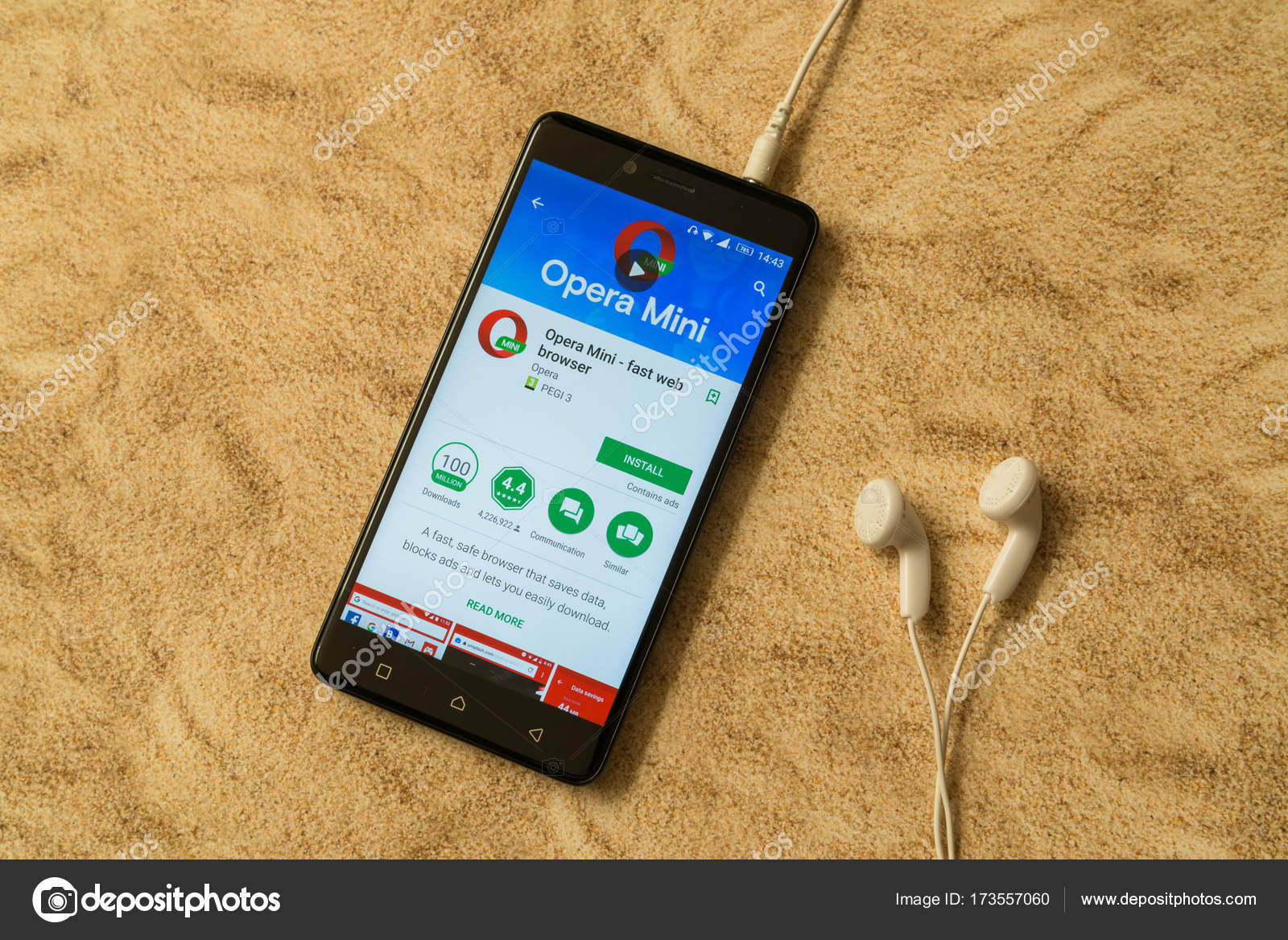 Opera mini application in google play store on sandy background and earphones — Stock Editorial ...