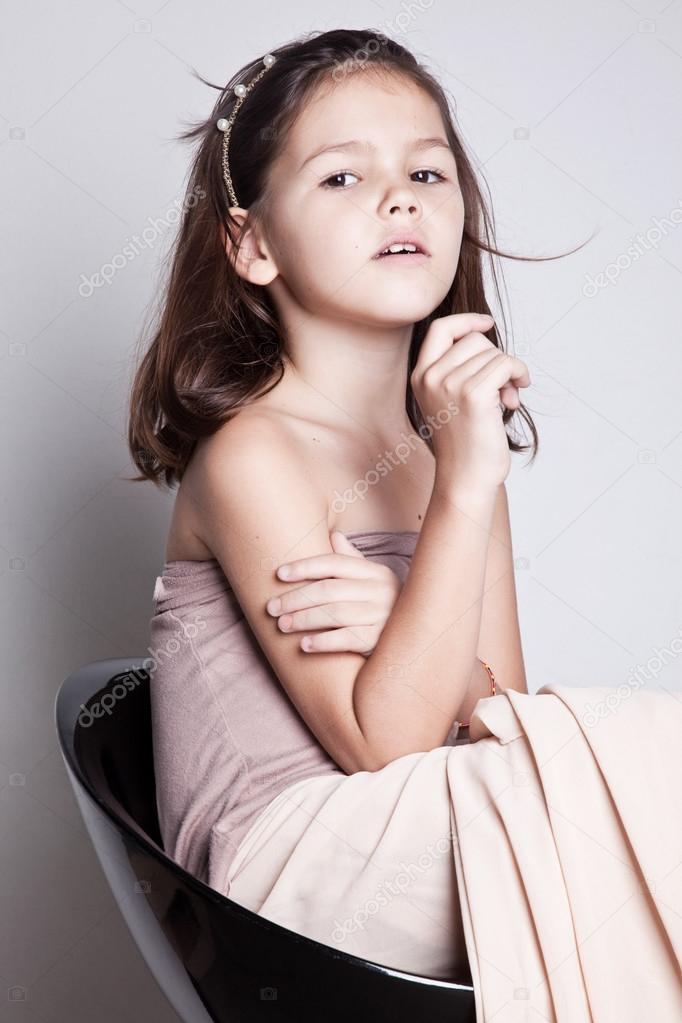 Little girl in the studio Stock Photo by ©RadaRani 128542442