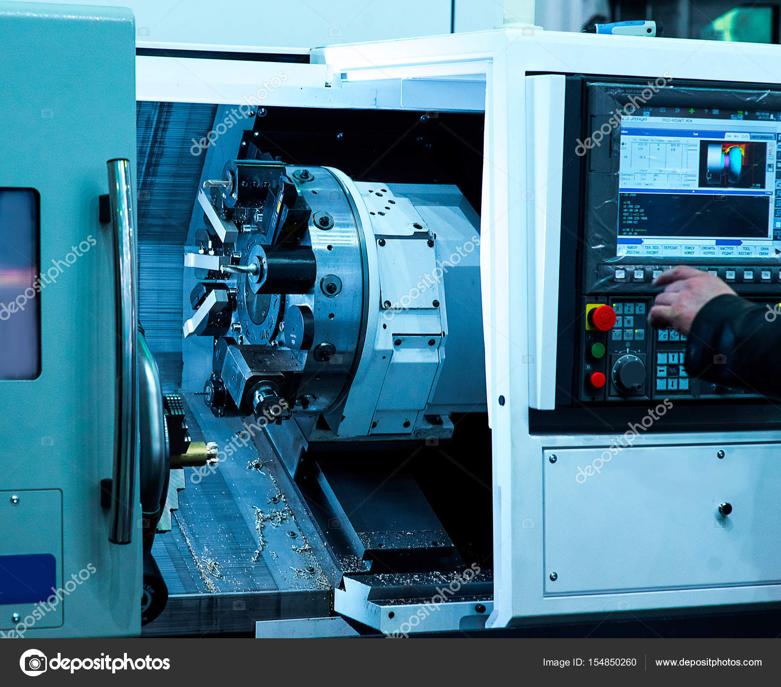 Operator machining automotive part by turning machine, Industry machine ...
