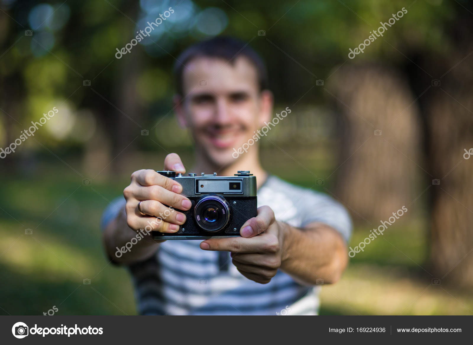 Young man holding in hands old vintage camera — Stock Photo ...