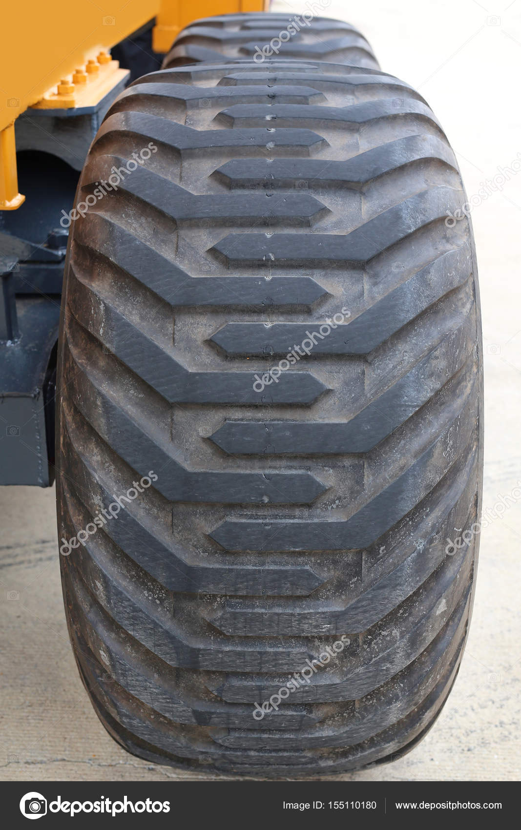 Yellow tractor with a big wheel. Wheel with a large tread — Stock Photo ...