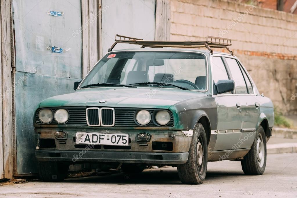 Old rusty sedan car BMW 3 Series, E30, parking on street. The BMW ...