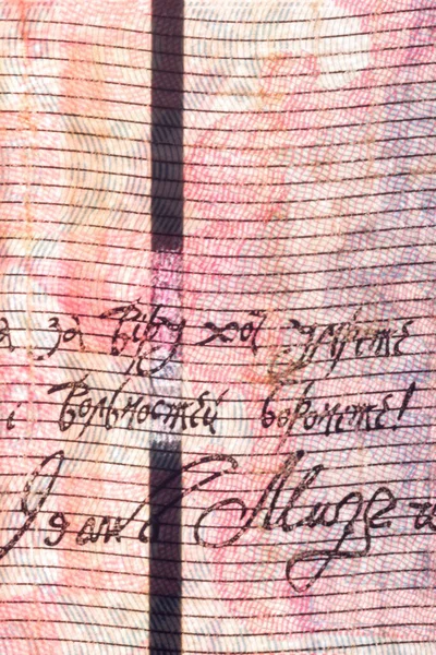 Tira de seguridad de plástico dentro del billete de 10 UAH. Tira de seguridad en el billete de ...