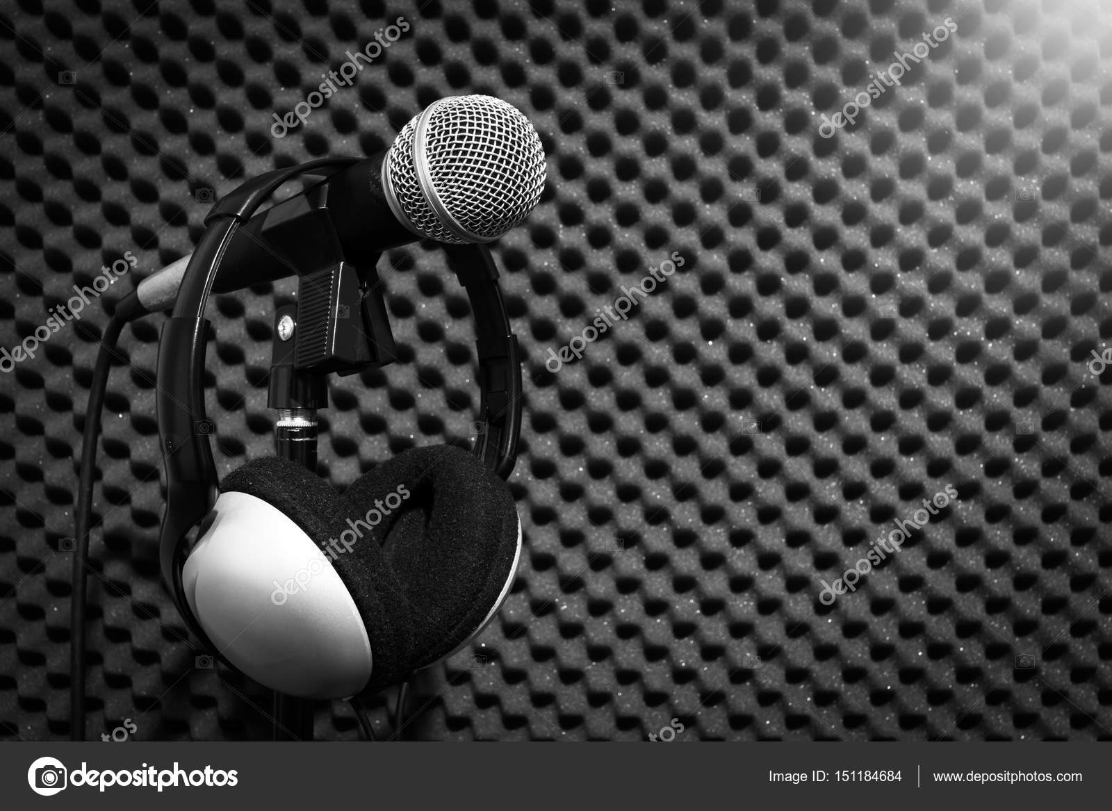 Microphone & headphone on acoustic board background in recording studio ...