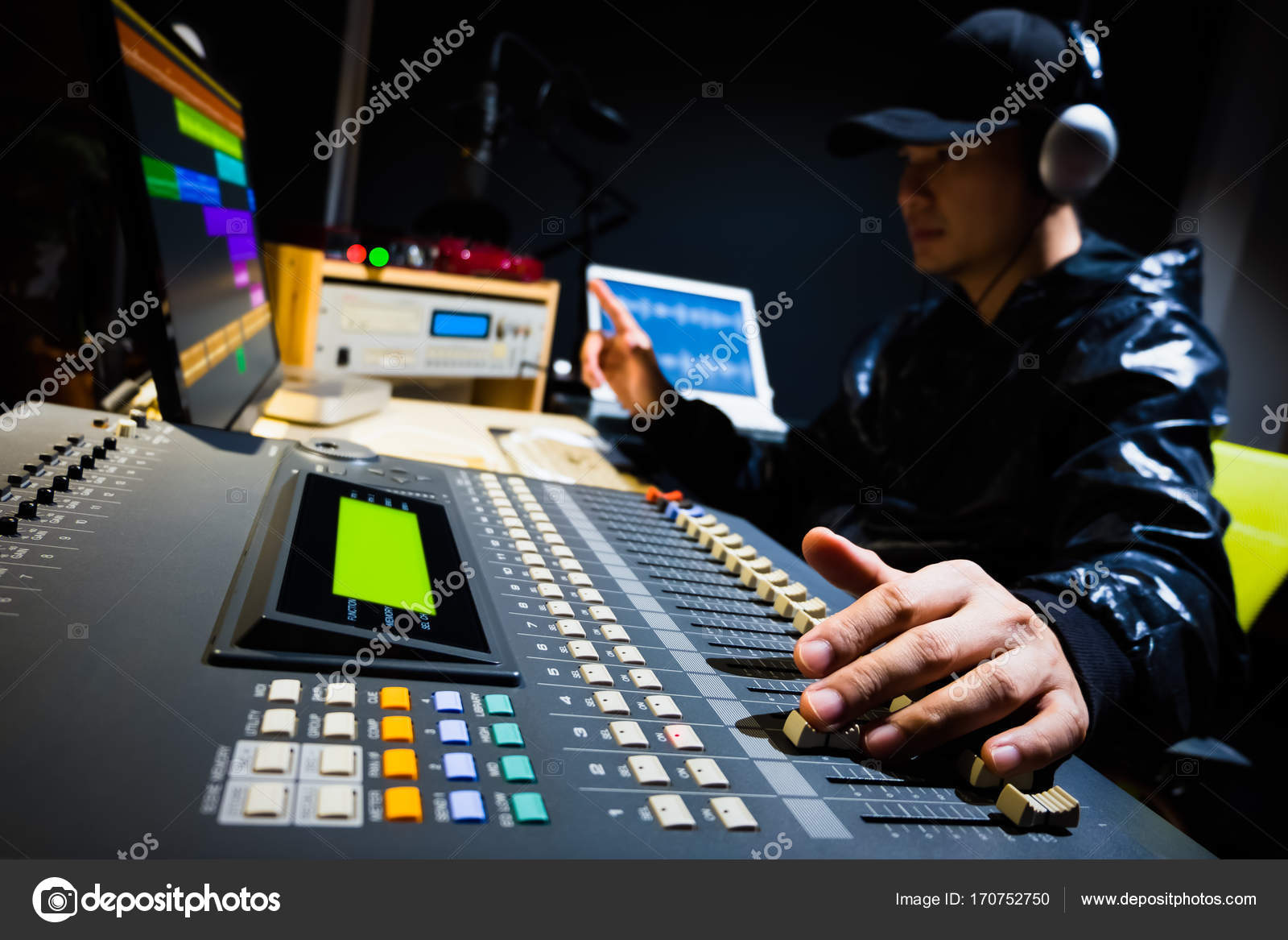 Asian male sound engineer working in digital audio & video editing post ...