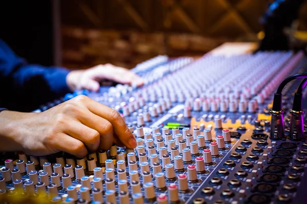 producer, sound engineer hands working on audio mixing console in ...
