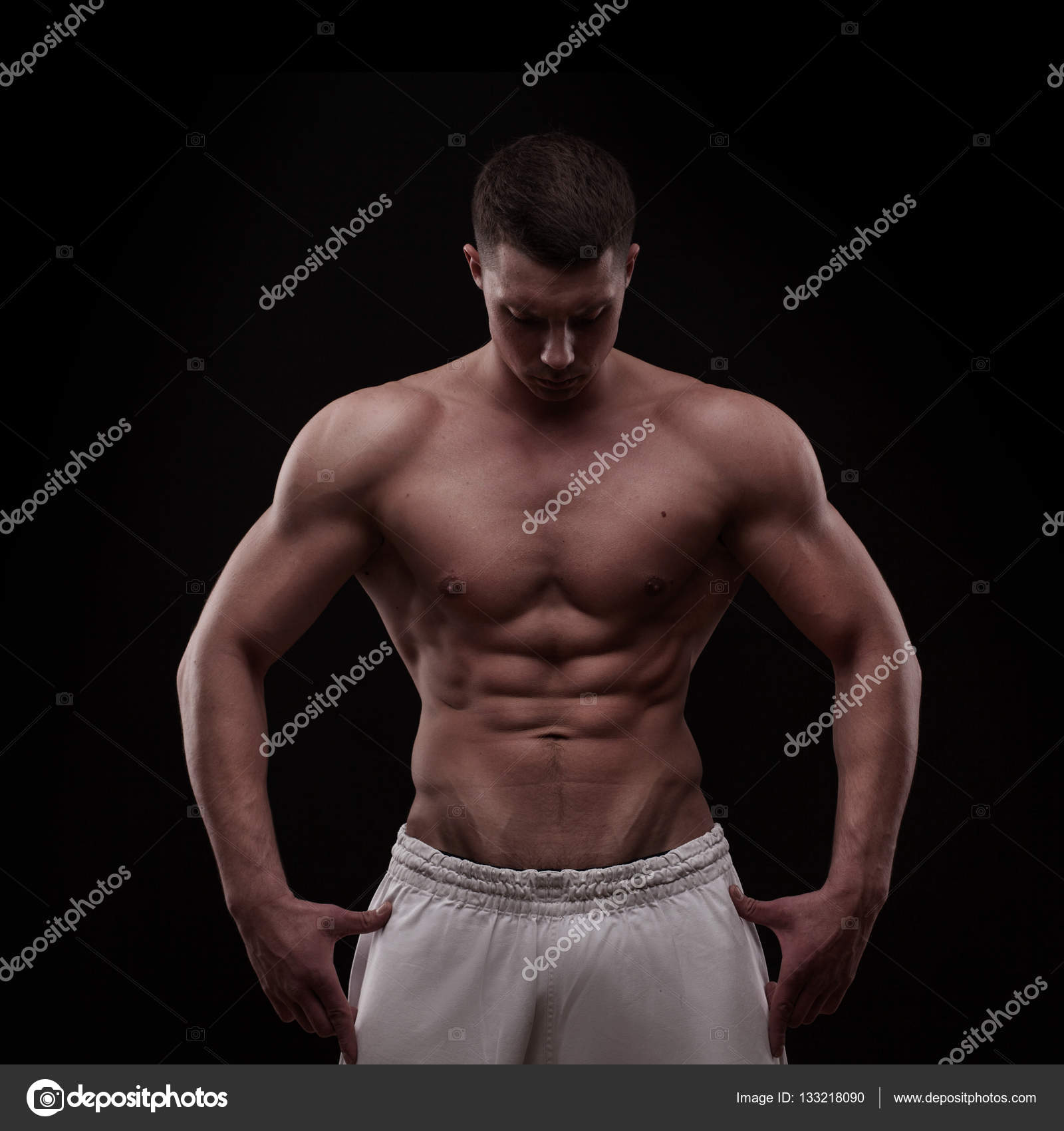 Young athlete bodybuilder man Stock Photo by ©doodko 133218090