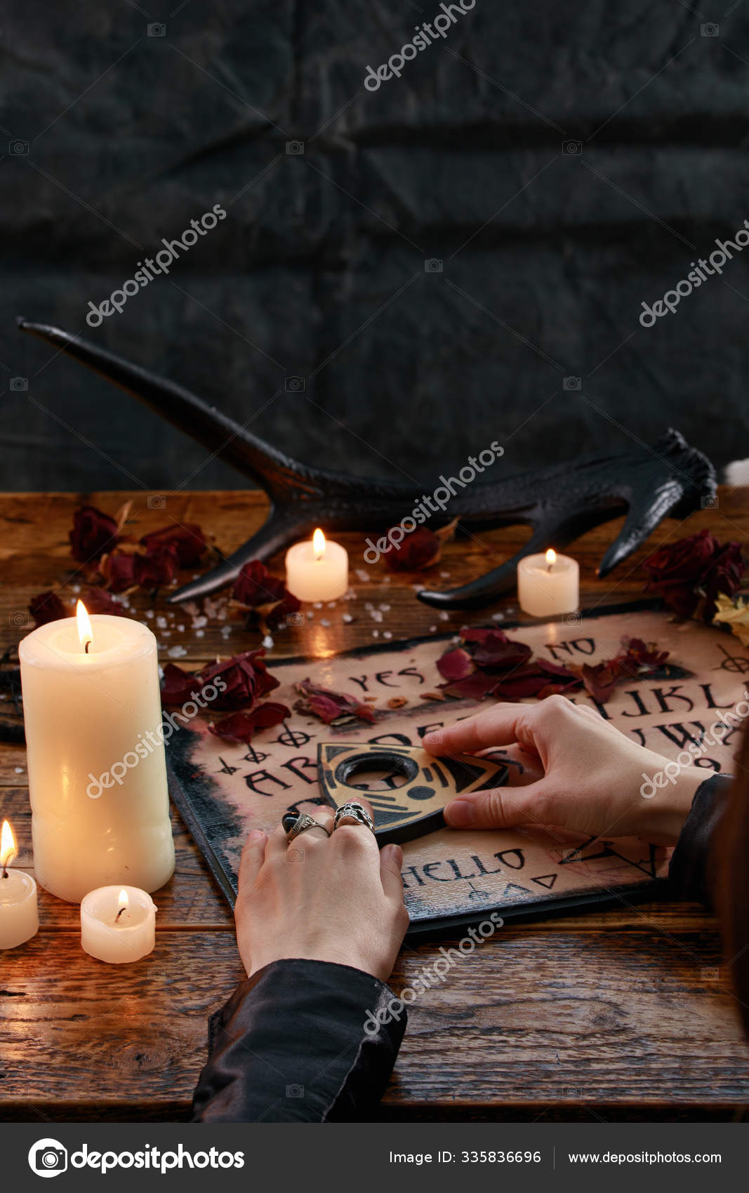 Mystic ritual with Devil's board and candles. The girl calls spirits ...