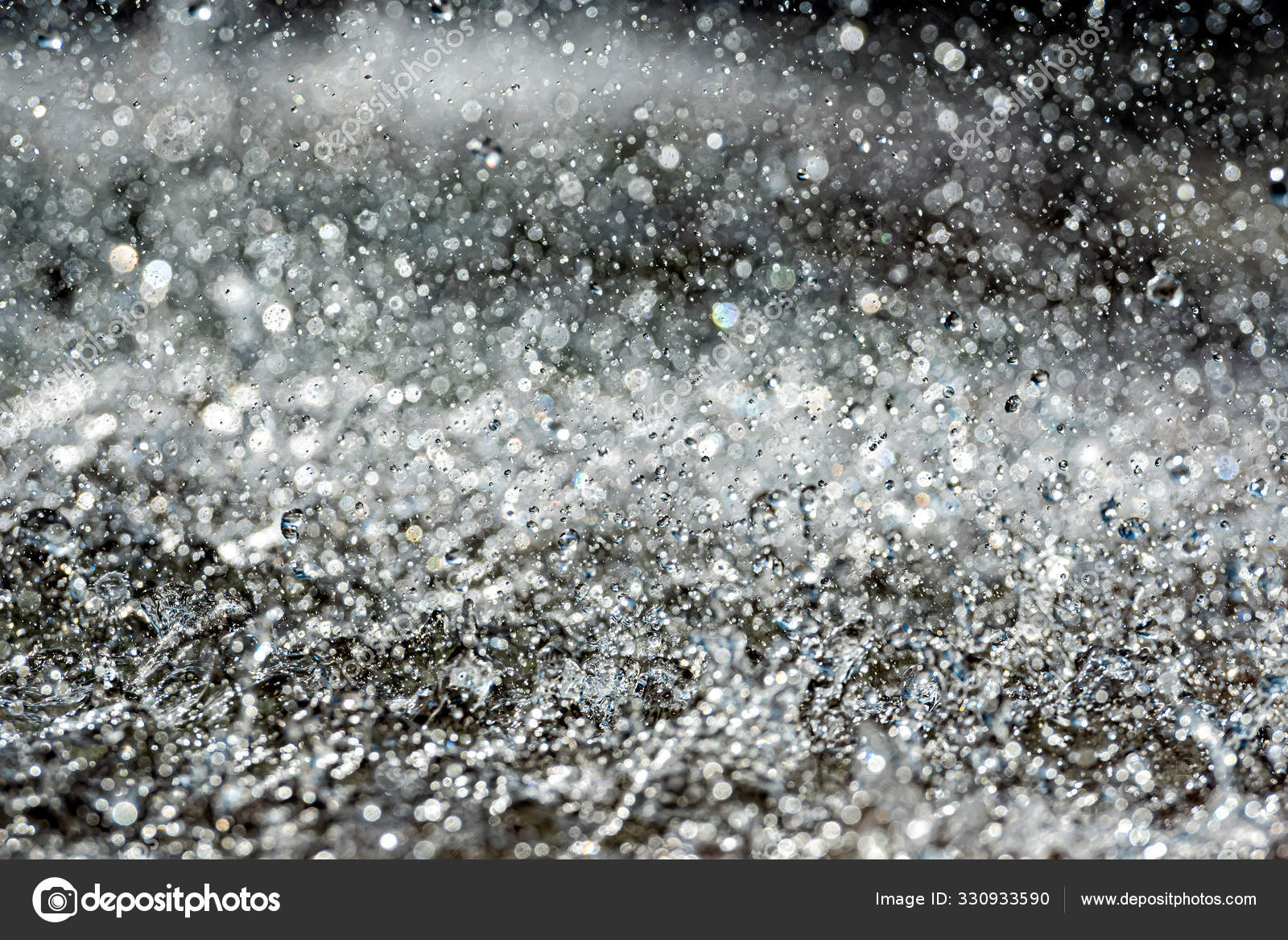 Water splash with small drops in the fountain. Abstract natural ...