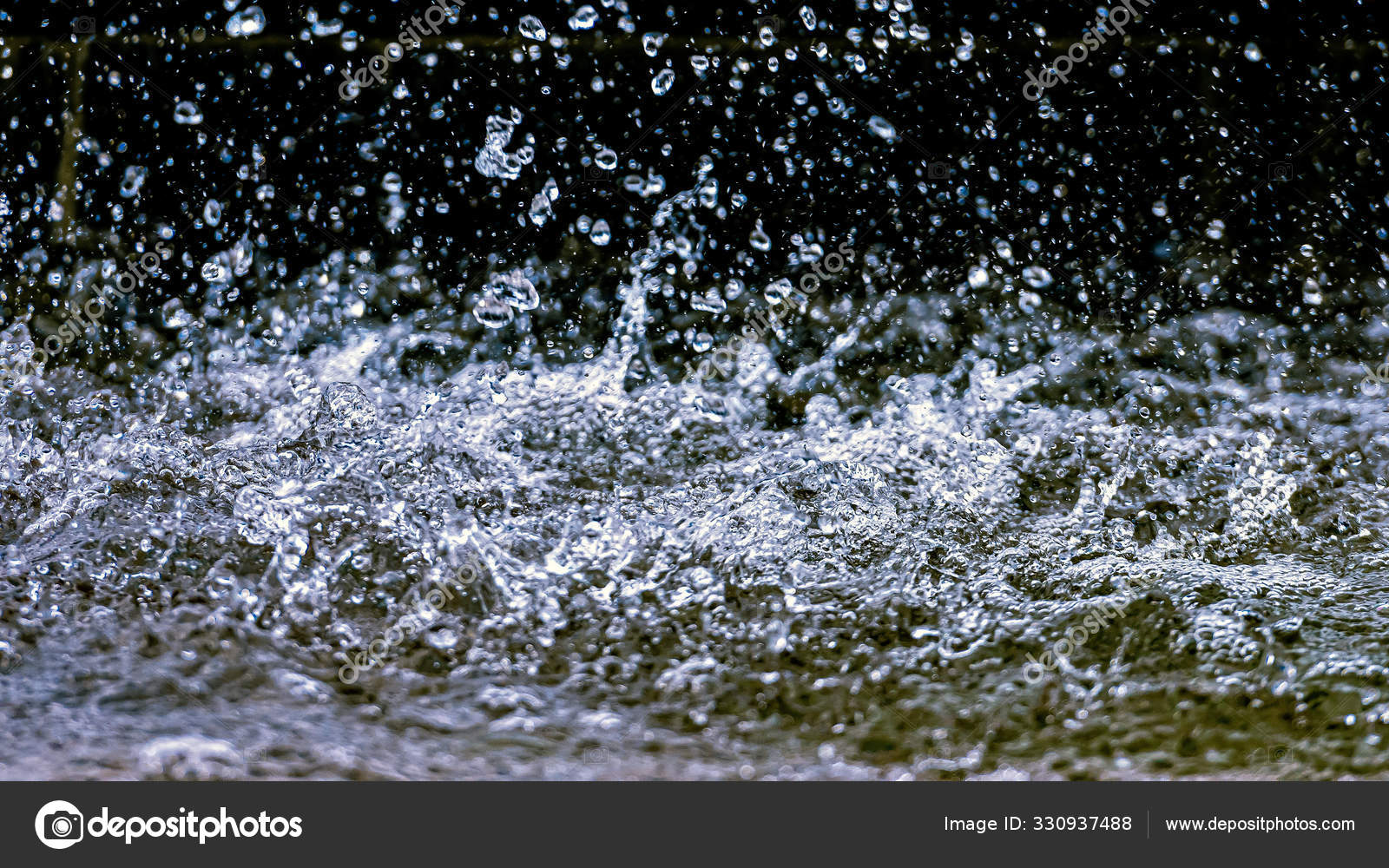 Water splash with small drops in the fountain. Abstract natural ...