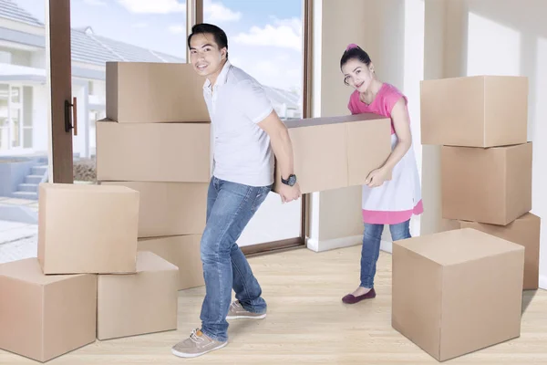 Asian Young Couple Carrying Big Cardboard Box Together While Moving