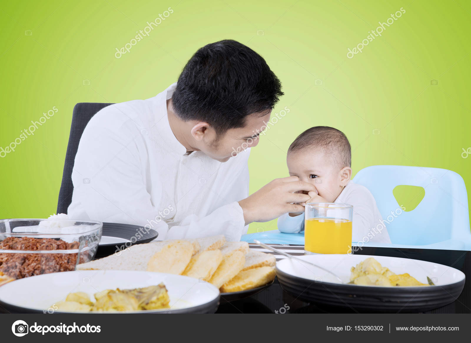 Man feeding his baby with hand Stock Photo by ©realinemedia 153290302