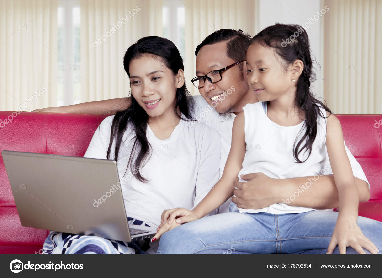 Parents and child using a laptop together Stock Photo by ©realinemedia ...