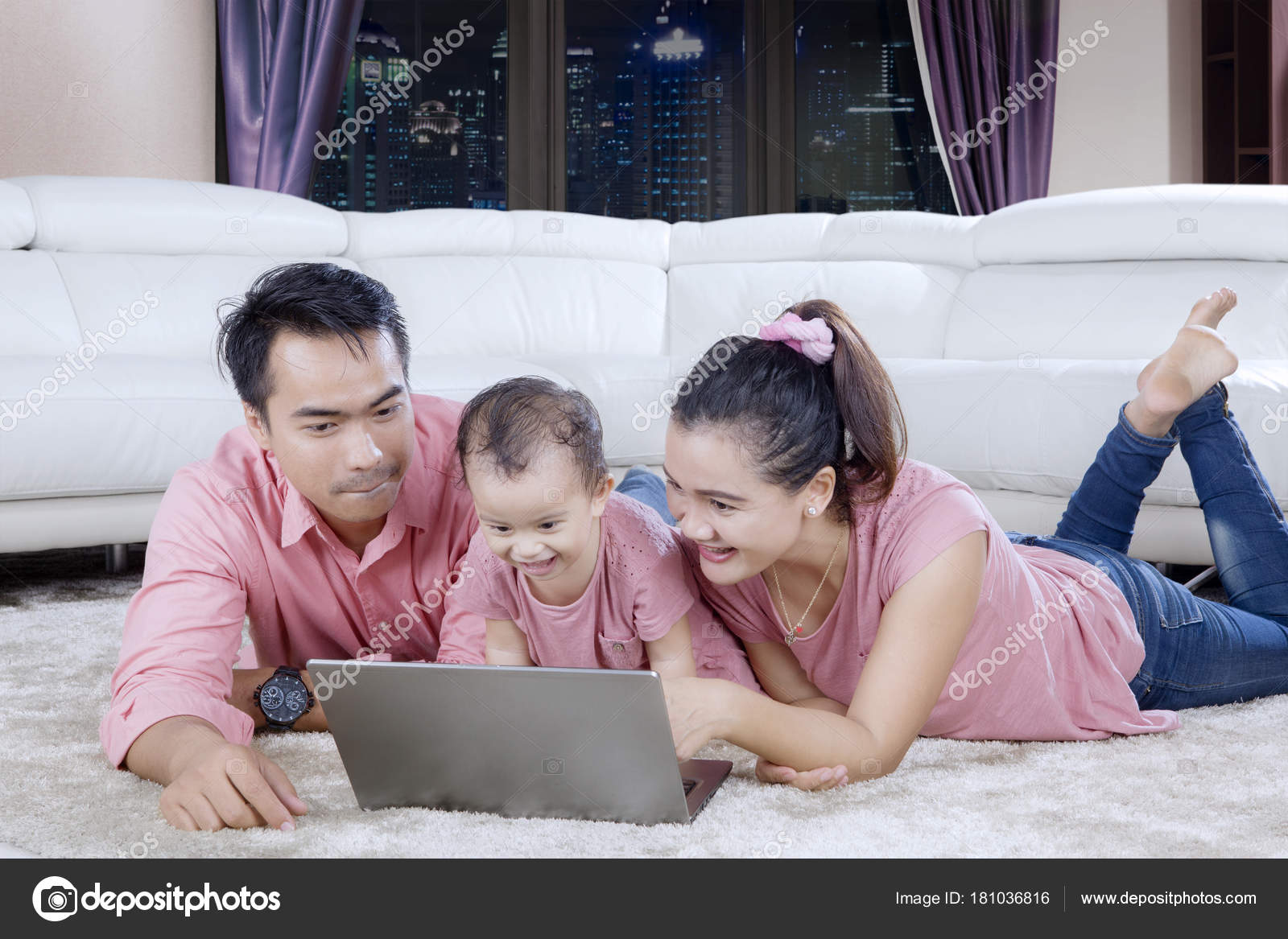 Happy parents using a laptop with child Stock Photo by ©realinemedia ...