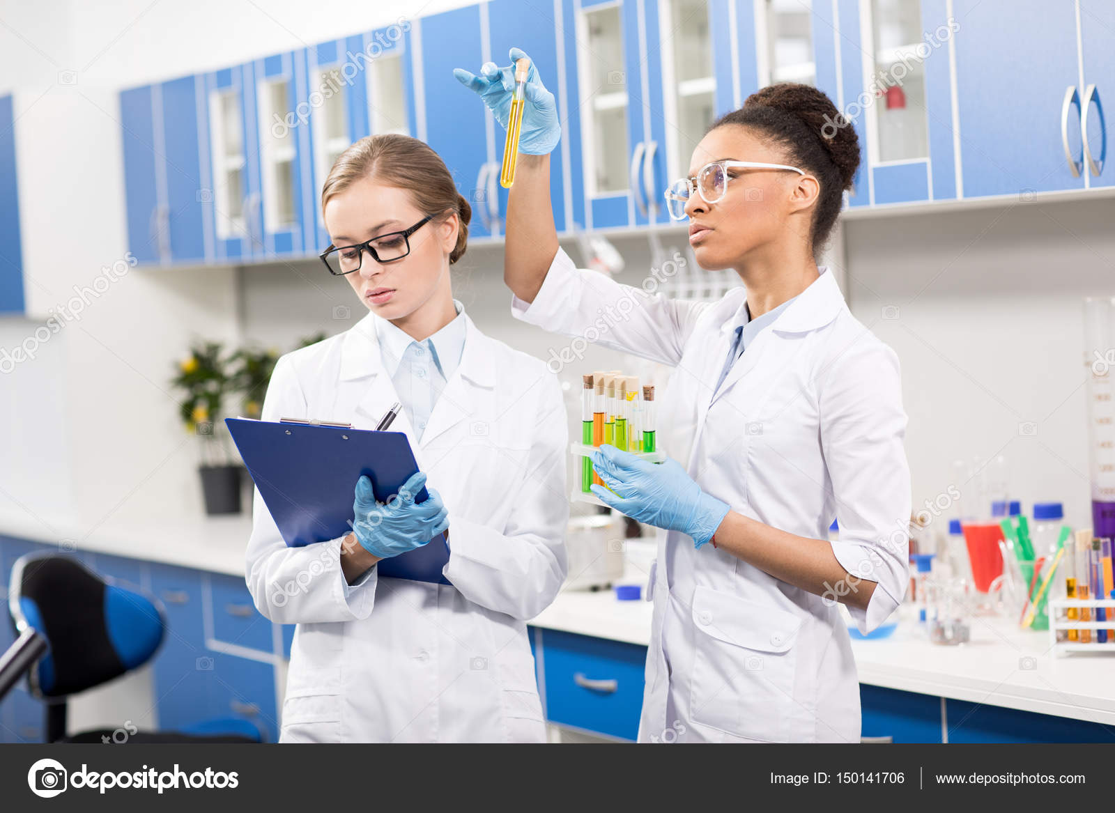 Scientists working with test tubes — Stock Photo © AlexFedorenko #150141706 Scientists working with test tubes — Stock Photo © AlexFedorenko #150141706
