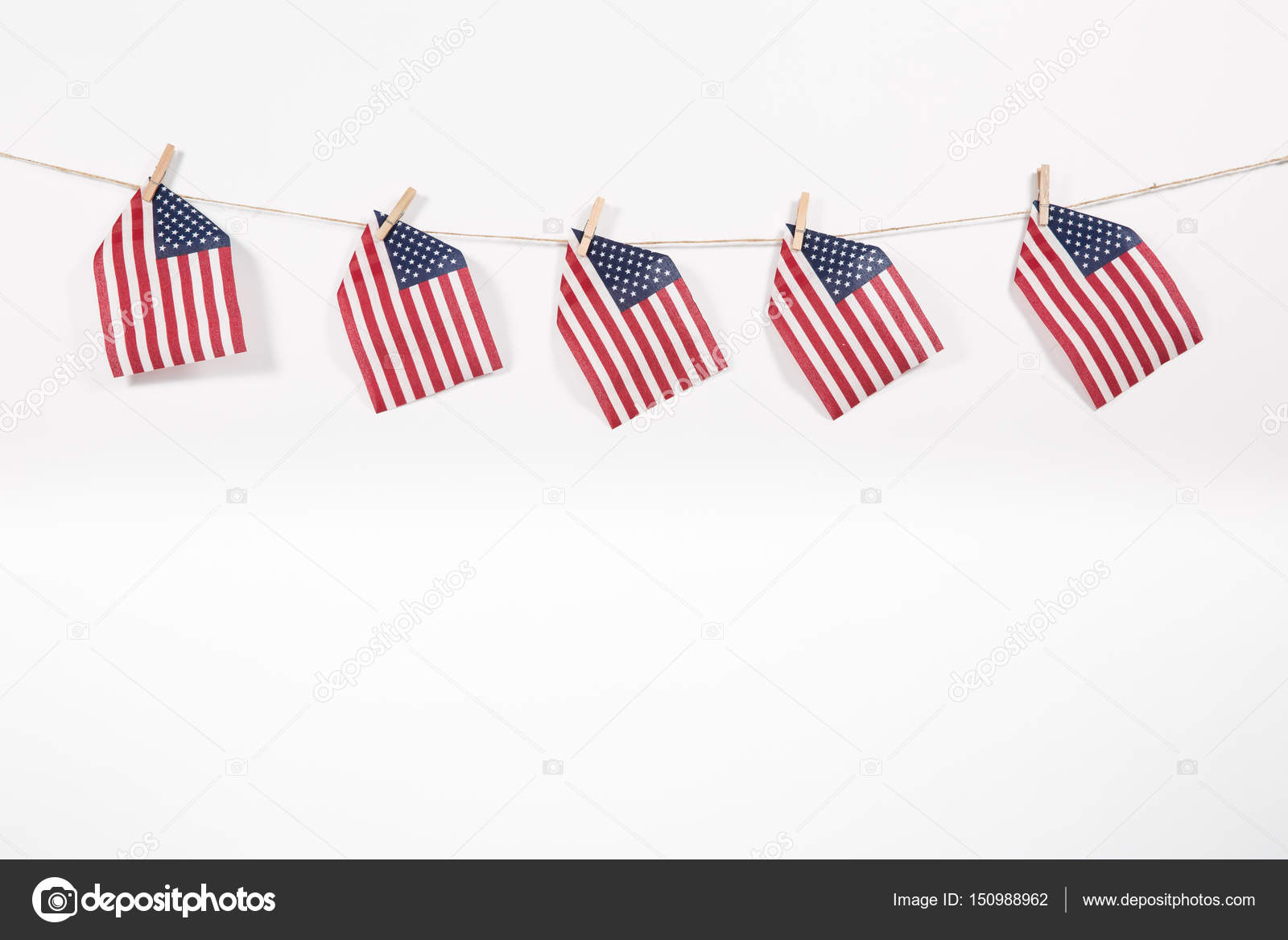 Miniature American flags hanging on a clothesline isolated white ...