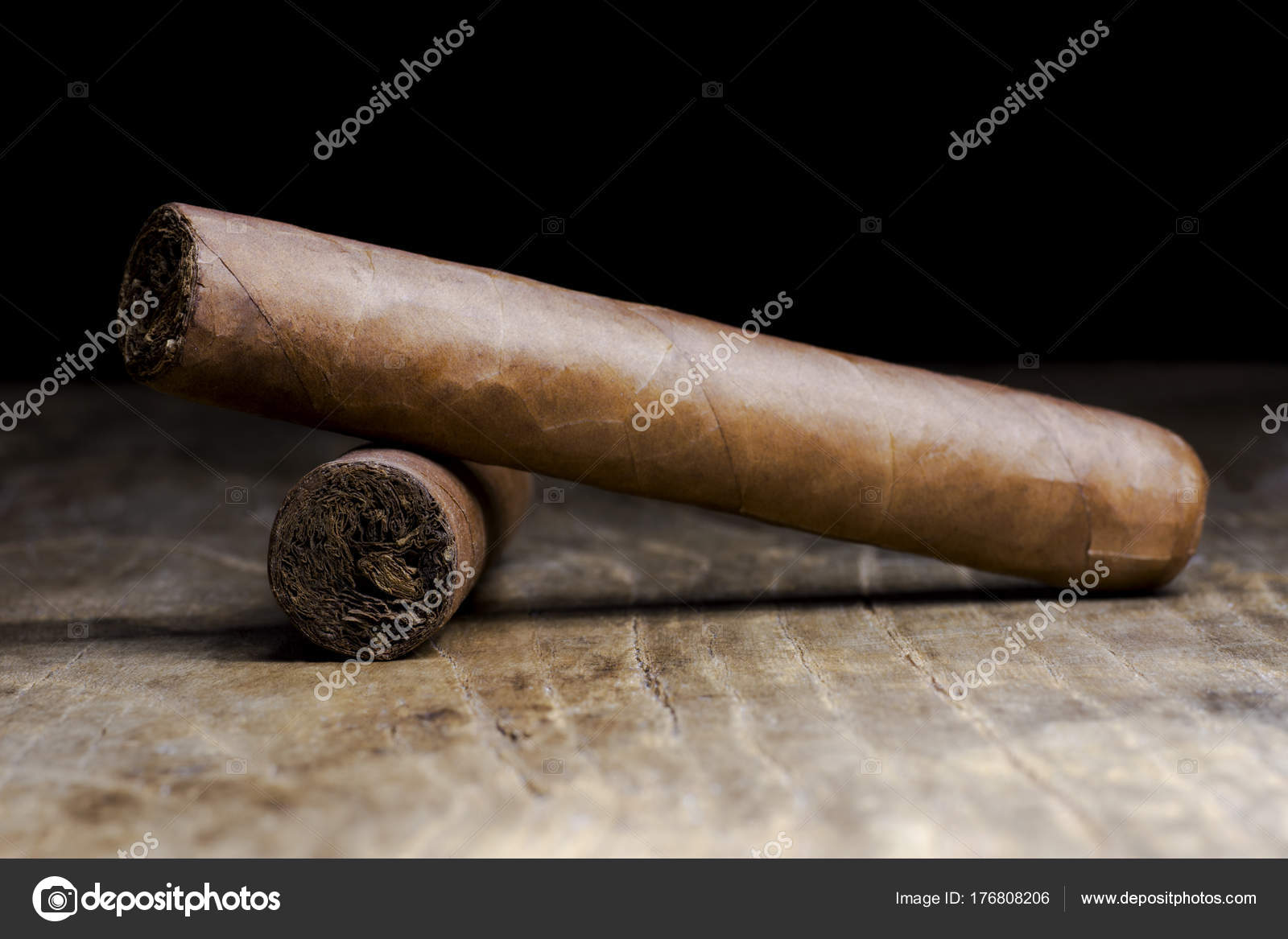 Two Cuban cigars lying on an old wooden table — Stock Photo © Forgem ...