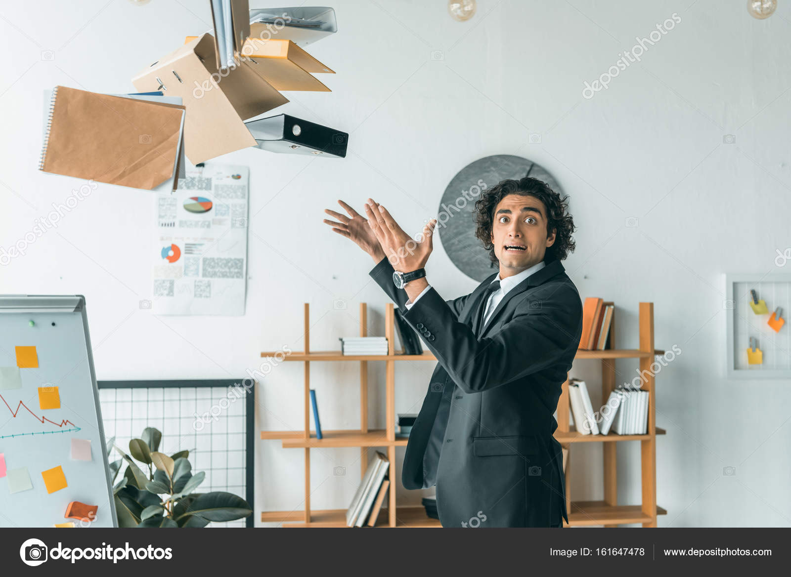 Businessman throwing folders in office — Stock Photo © AlexNazaruk ...