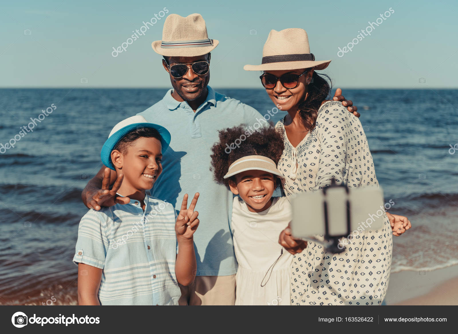 Family taking selfie at seaside Stock Photo by ©AlexNazaruk 163526422