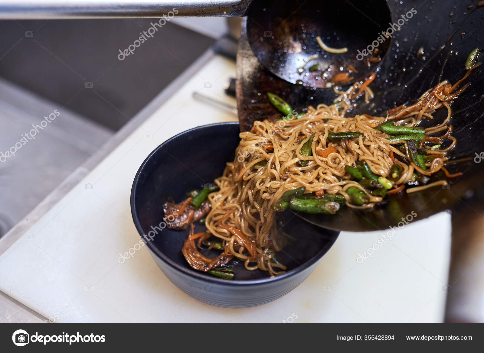 Cooking process fried noodles with vegetables in the wok, traditional ...