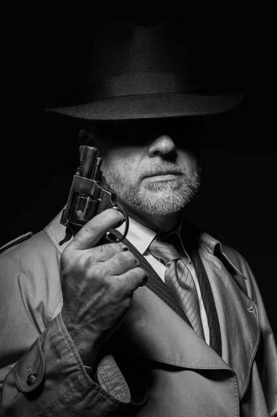 Detective holding gun in dark — Stock Photo © stokkete #142169500